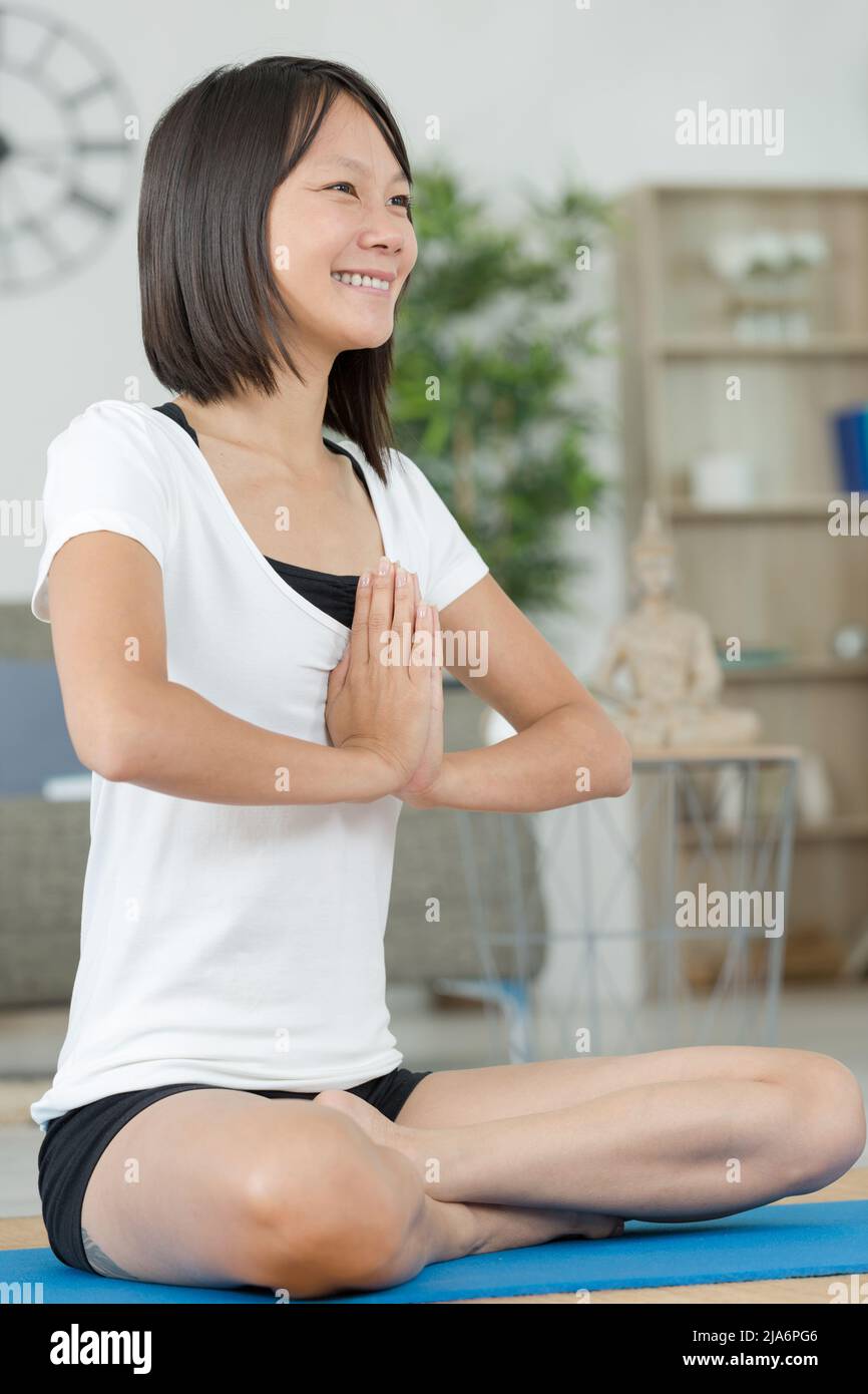 yogini sat in prayer position on yoga mat Stock Photo - Alamy