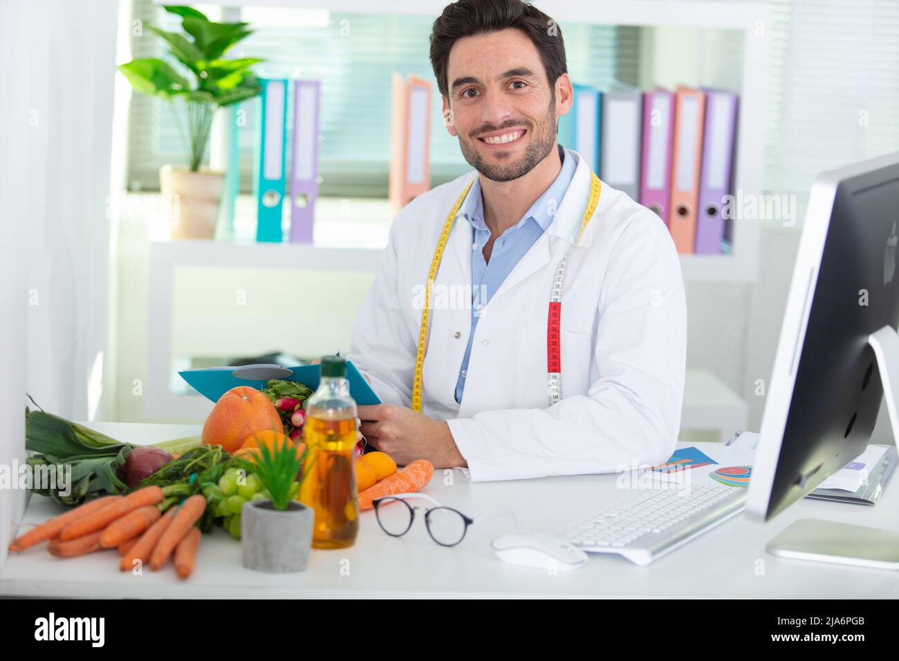 portrait of male nutritionist in his office Stock Photo - Alamy