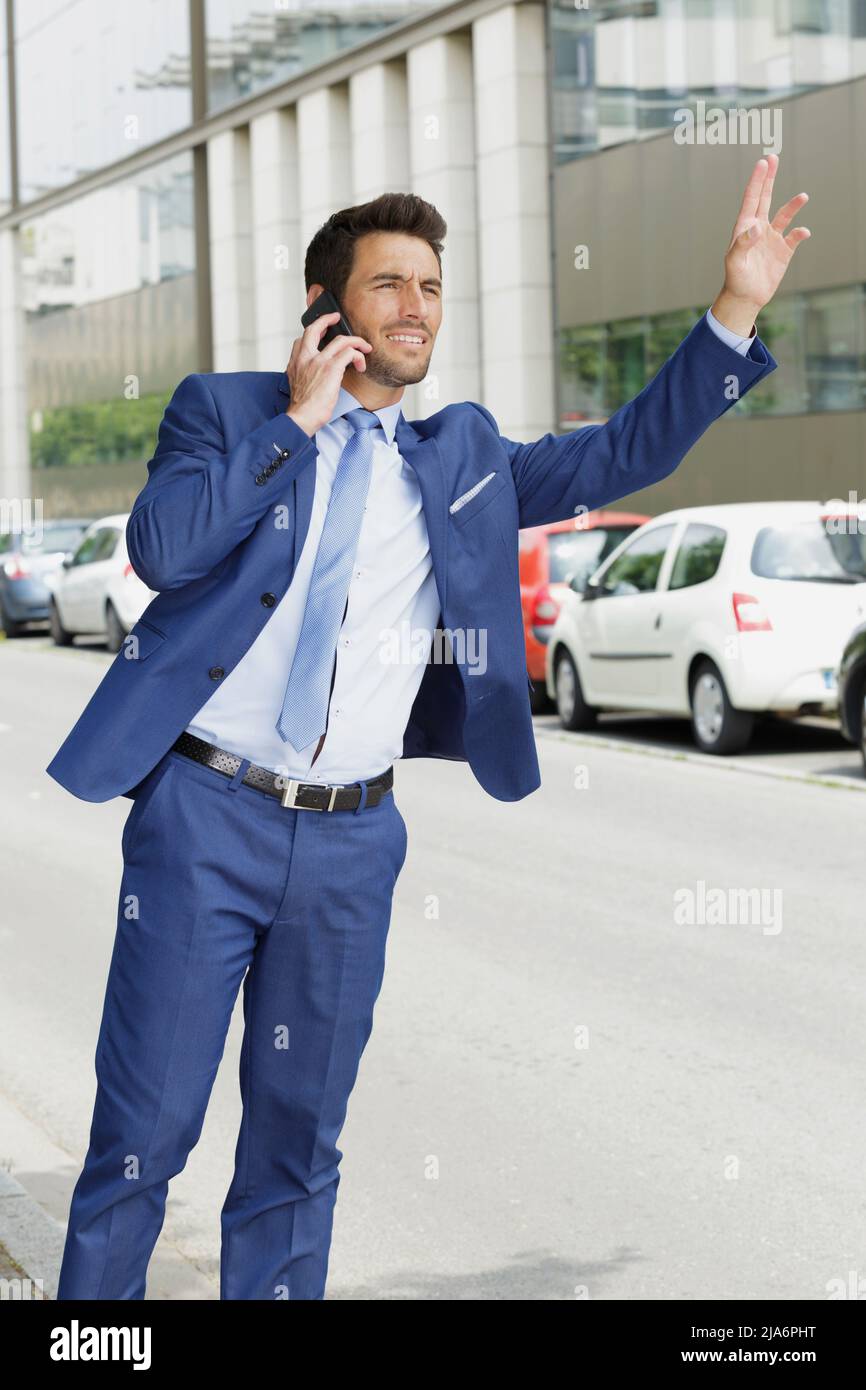 portrait of a man calling for a taxi Stock Photo - Alamy