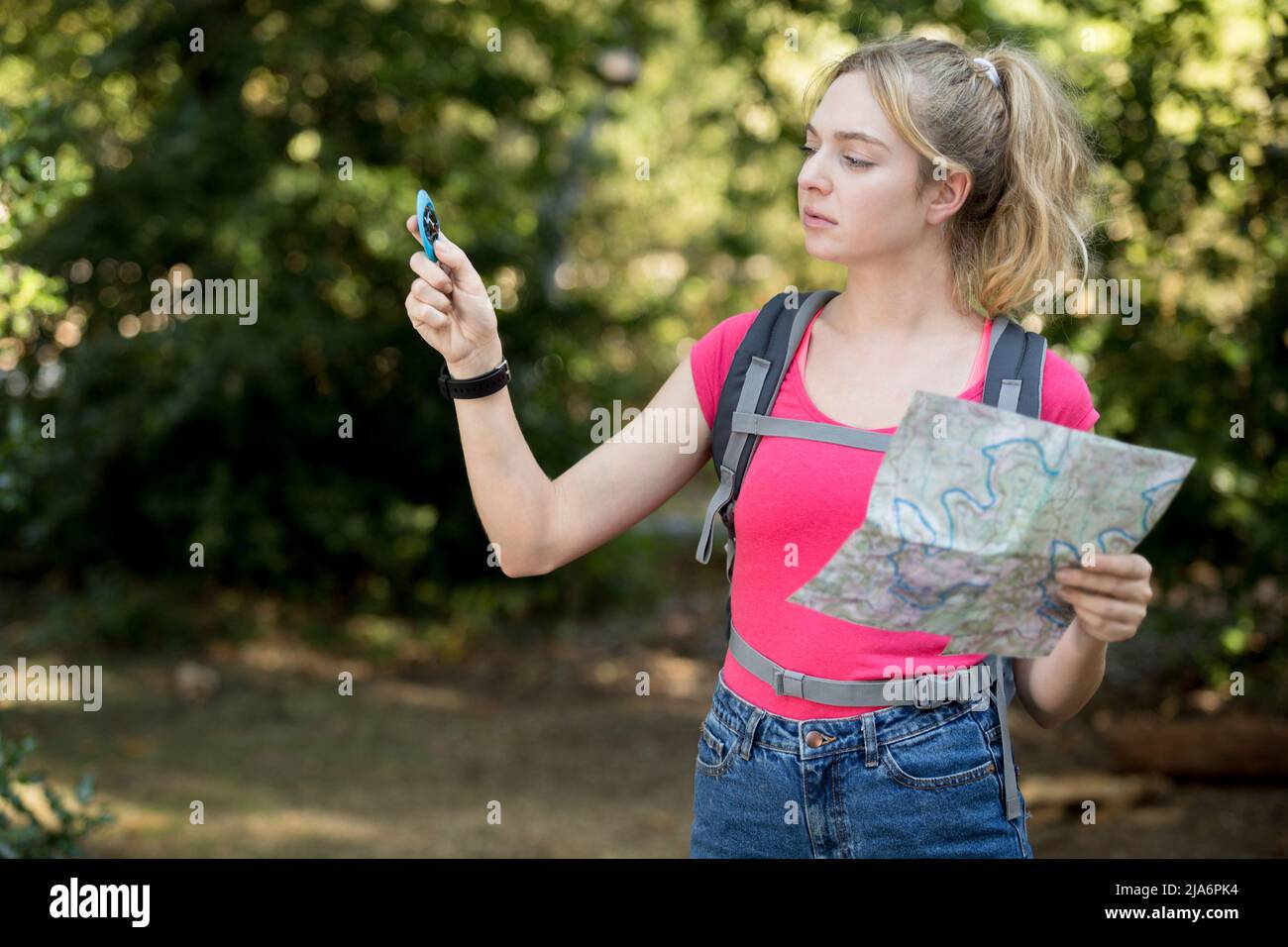 attractive young woman holding a map Stock Photo - Alamy