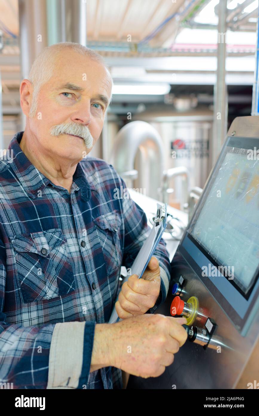 senior man worker in factory Stock Photo - Alamy