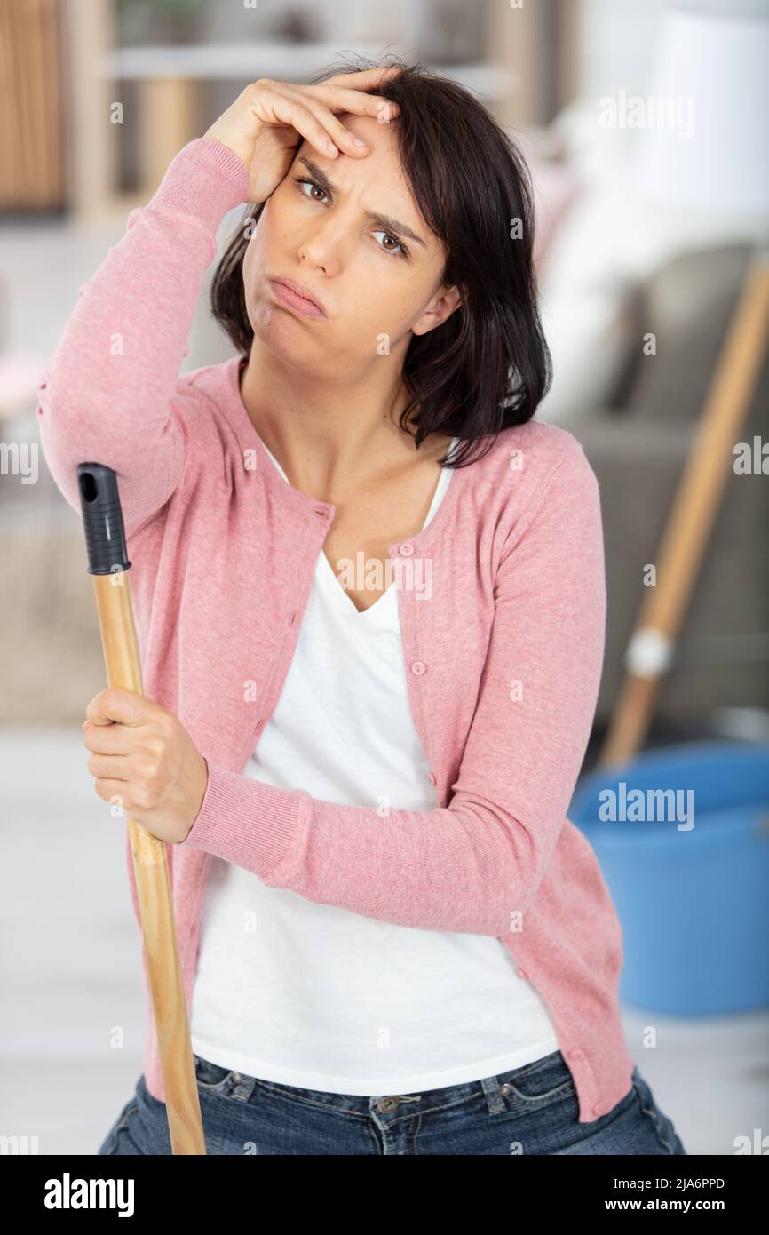 unhappy woman during house chores Stock Photo - Alamy