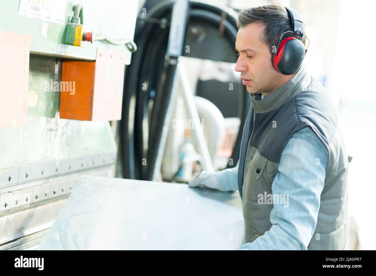 a man in metal workshop Stock Photo - Alamy
