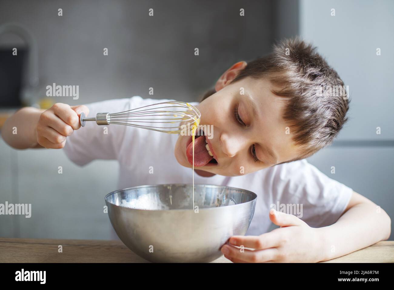 Boy stirring dough in bowl hi-res stock photography and images - Alamy