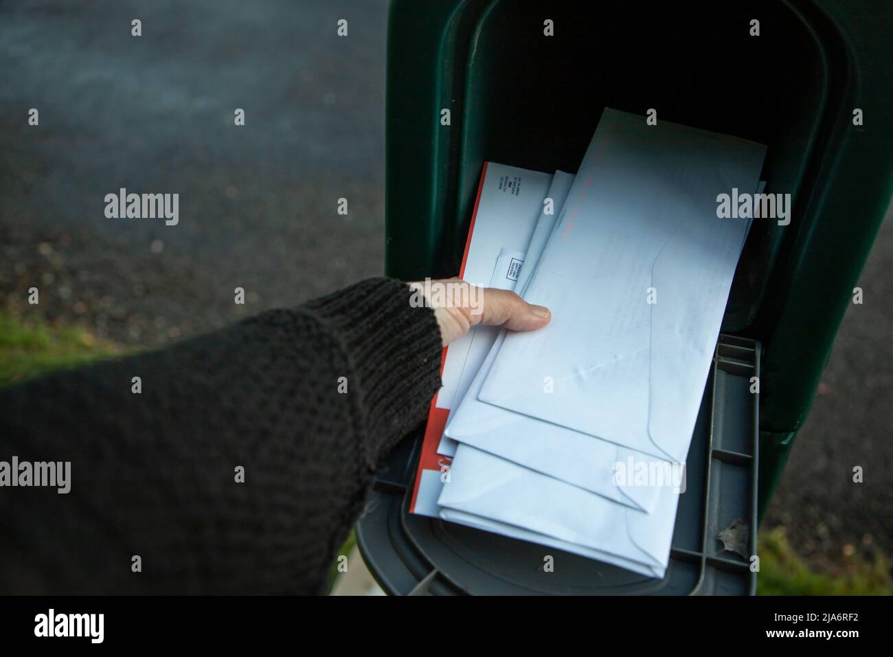 Getting mail out of the mailbox Stock Photo - Alamy