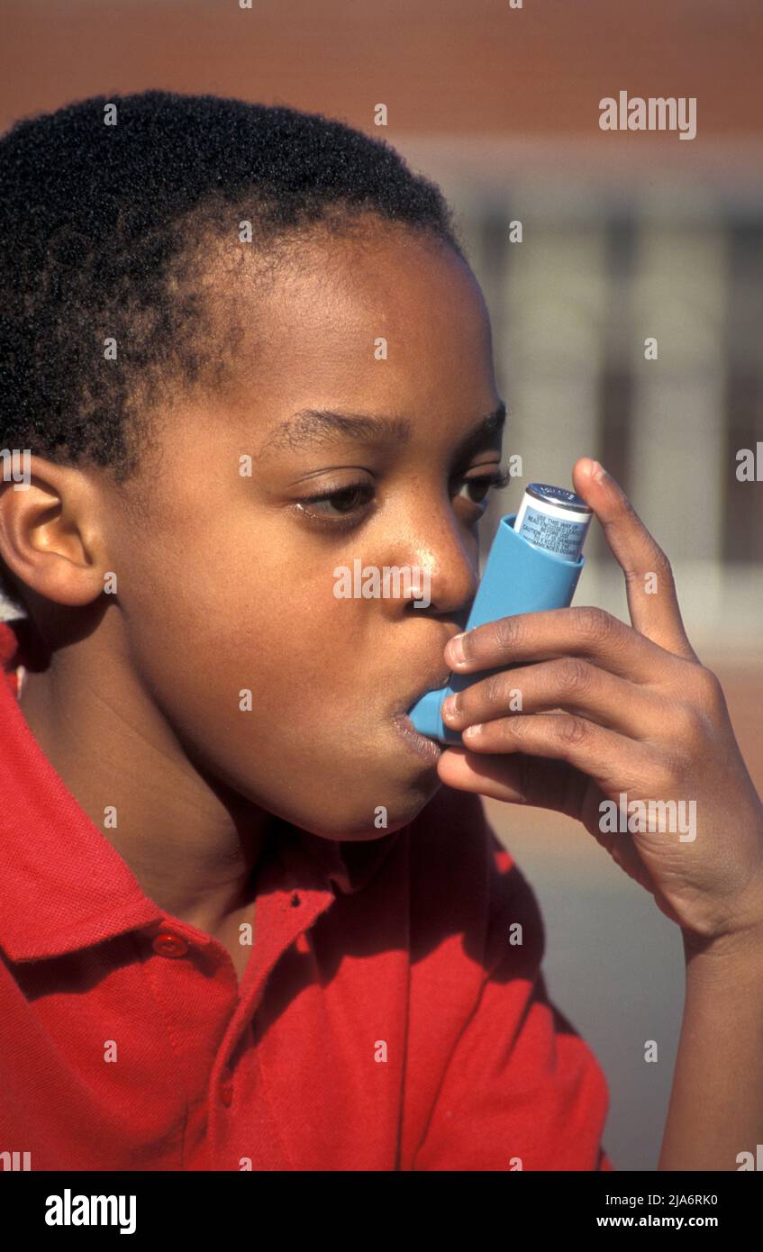 young black boy using salbutamol ventolin inhaler for asthma Stock ...