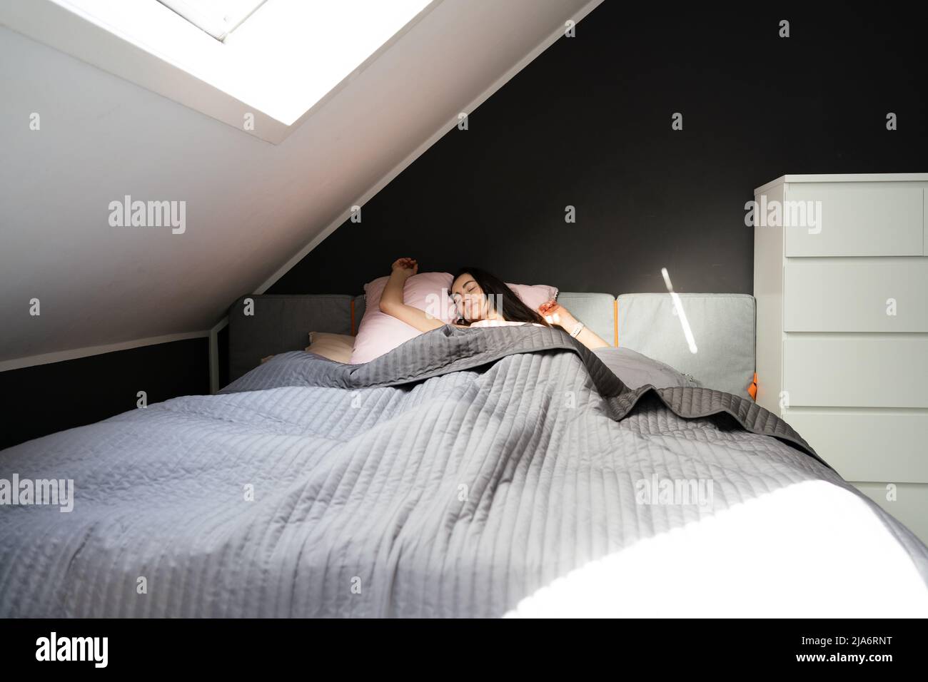 Woman is sleeping in bed. Time to wake up Stock Photo - Alamy