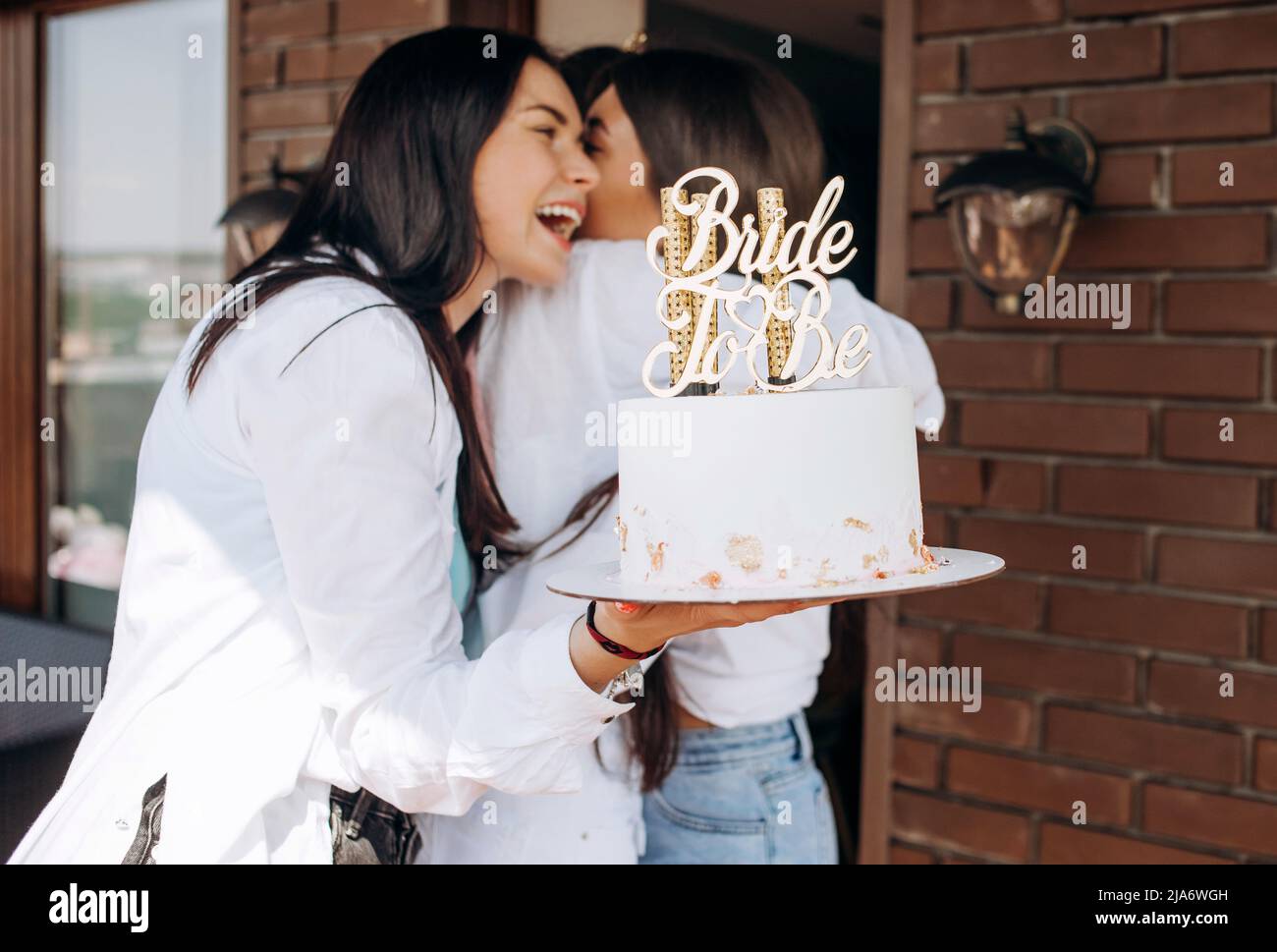 Bachelorette party. Holiday cake, hugs of girls Stock Photo - Alamy