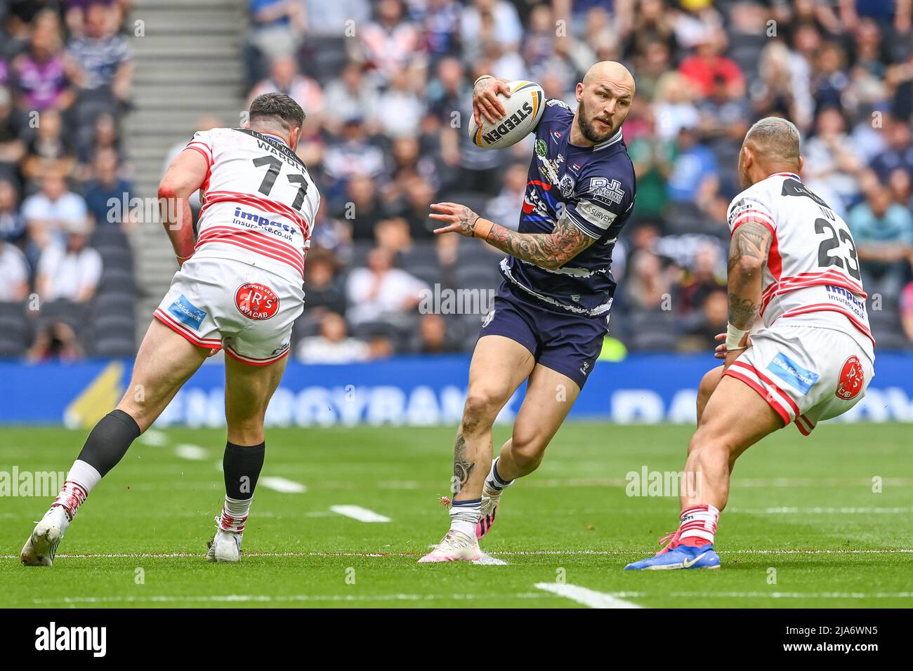 Luke Briscoe #2 of Featherstone Rovers breaks past Joe Wardle #11 of ...