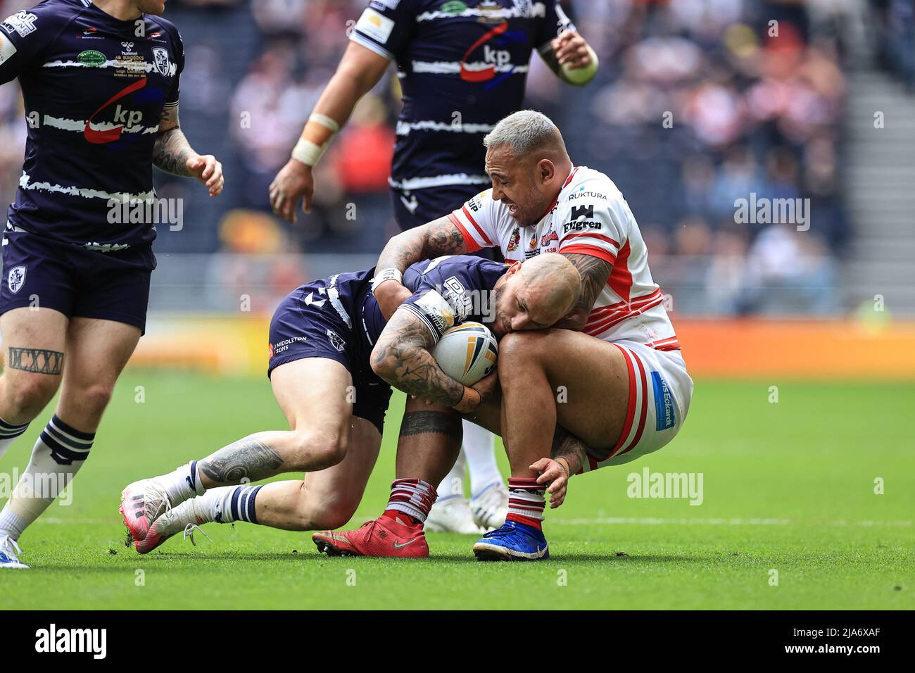 Luke Briscoe #2 of Featherstone Rovers is tackled by Kristian Inu #23 ...