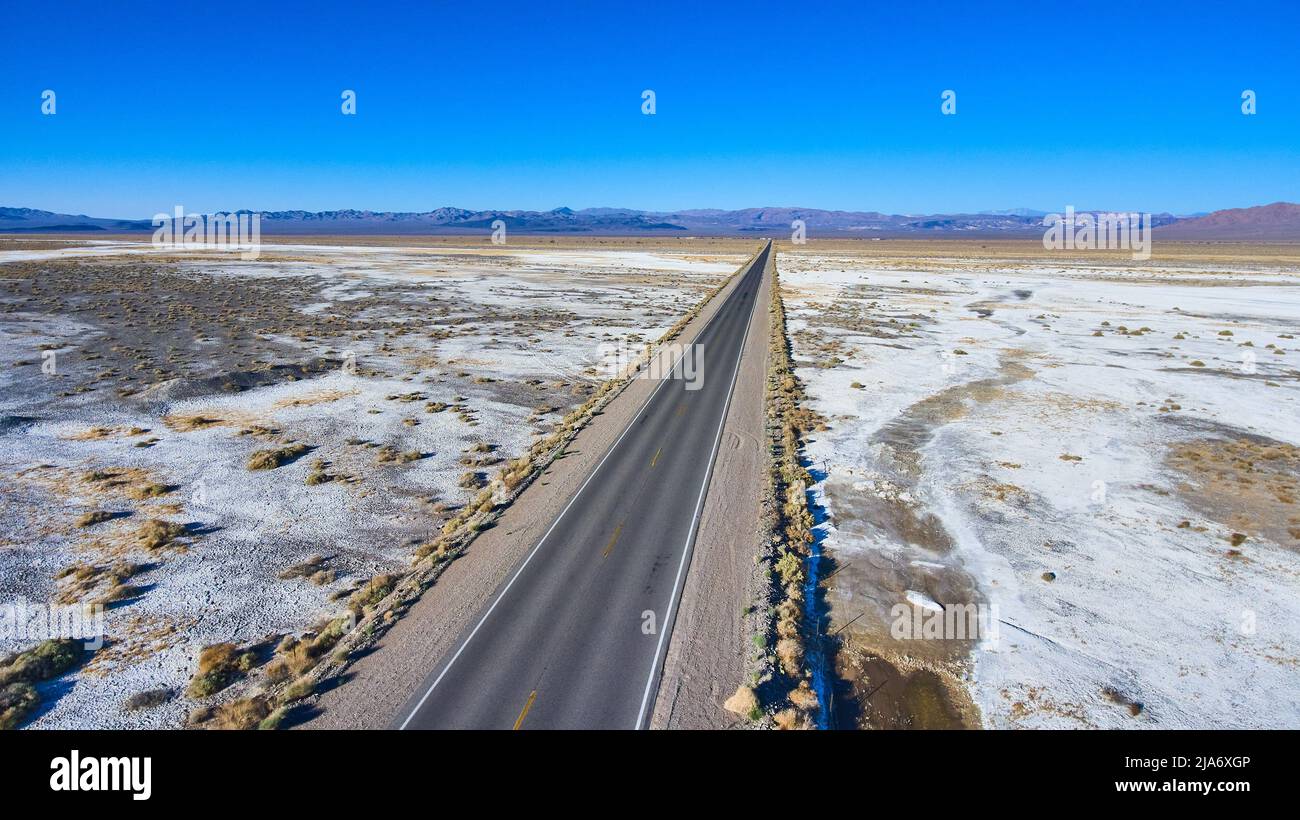Flat desert landscape with highway through center Stock Photo - Alamy