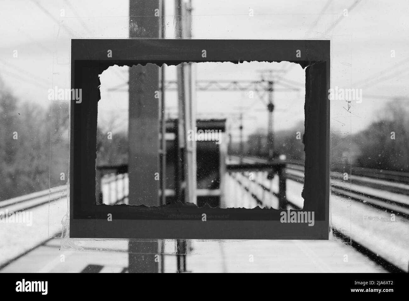 A window on the train station platform with a view of the railroad ...