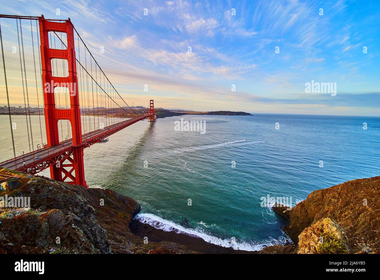 Iconic Golden Gate Bridge next to ocean beach waves from cliffs Stock ...