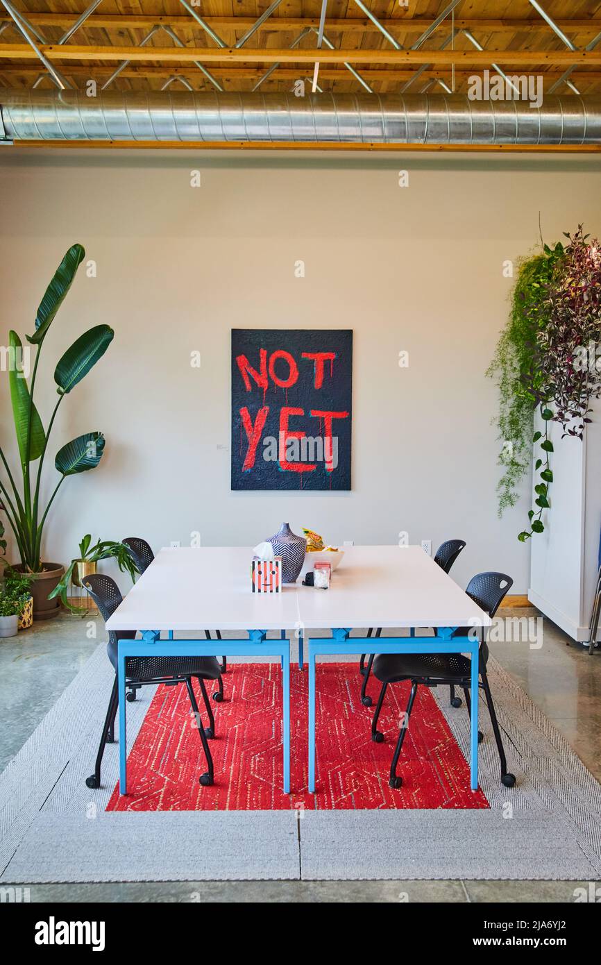 Coworking office table with plants and art Stock Photo - Alamy