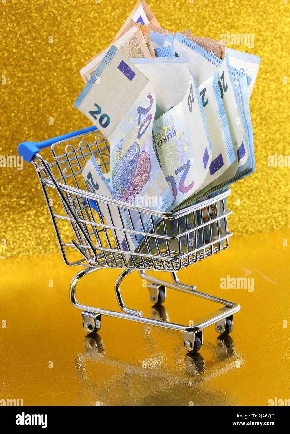 shopping trolley with a lot of european banknotes that the golden ...