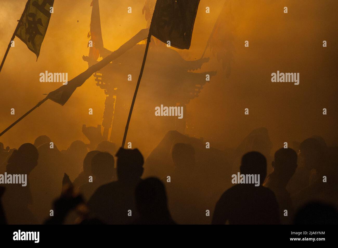 a litter (palanquin) being carried through atmospheric smoke from ...