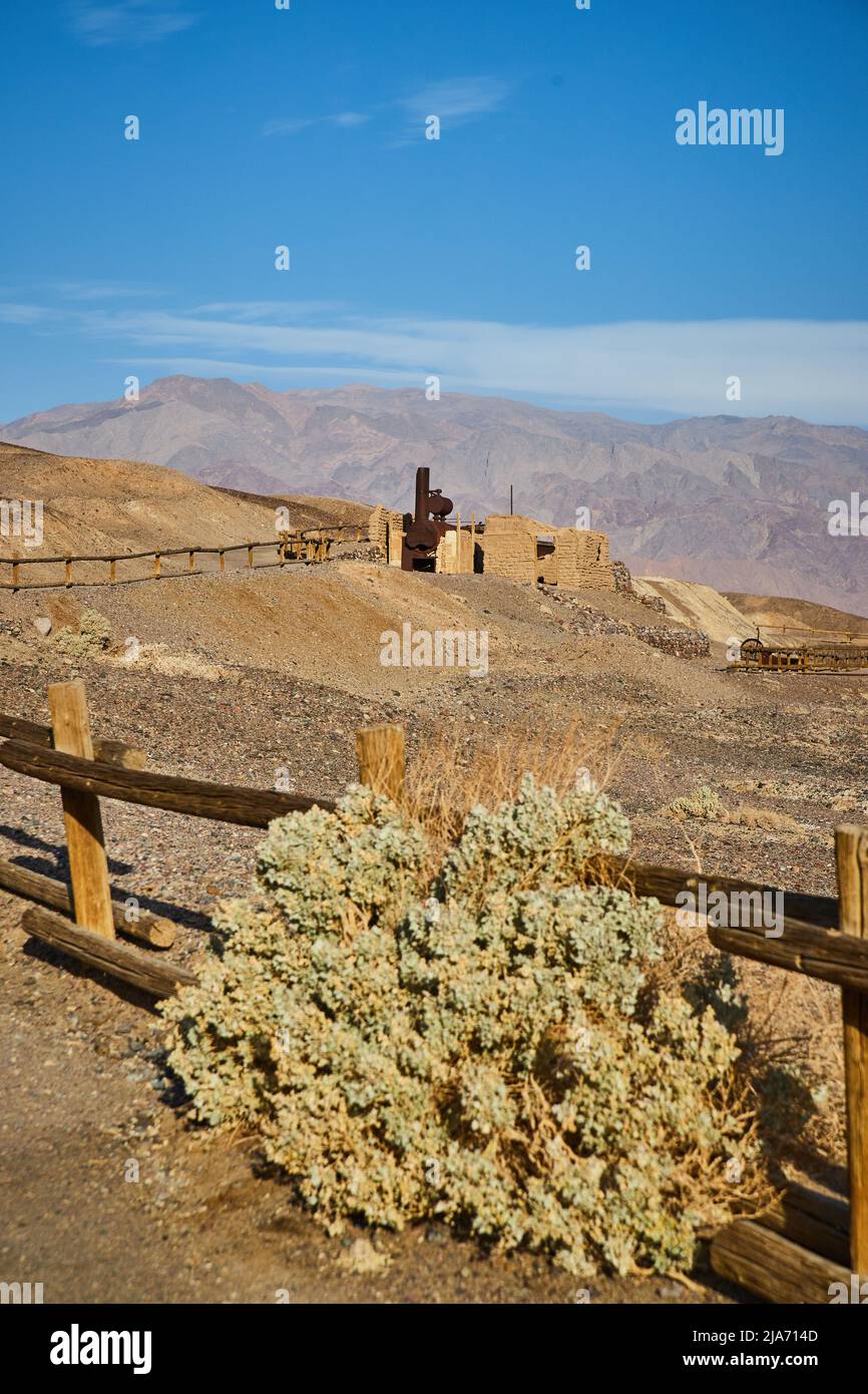 Death Valley wood fence and desert shrub by old structures Stock Photo ...