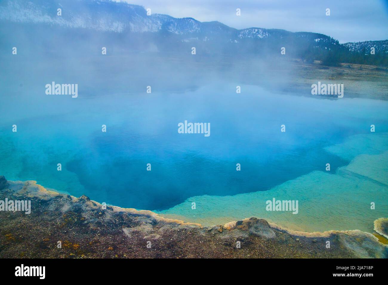 Huge blue pool emits sulfur steam in Yellowstone basin Stock Photo - Alamy