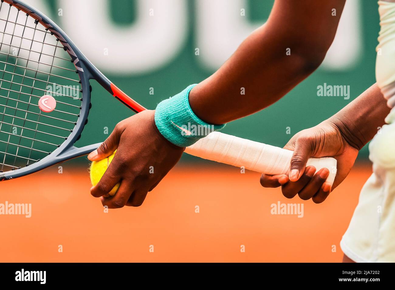 A tennis player prepares for a service at the 2022 French Open Grand ...