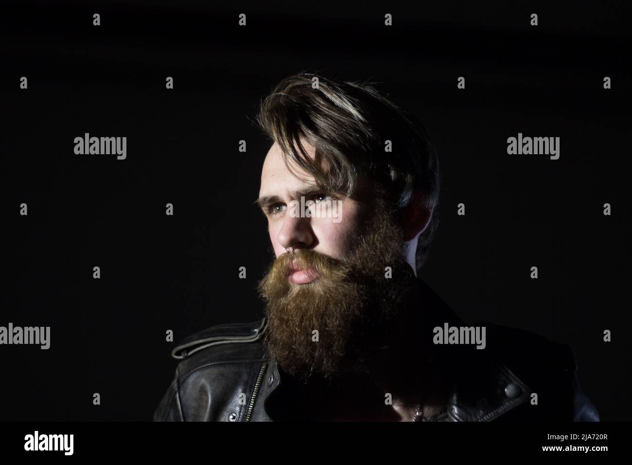 Brutal angry biker on a dark background Stock Photo - Alamy