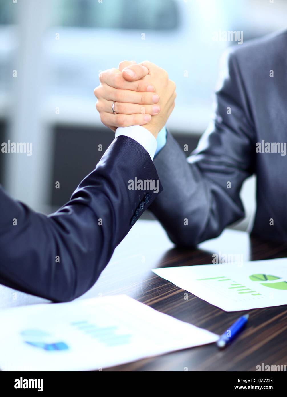 Two businessmen press hands each other on a forward background Stock ...