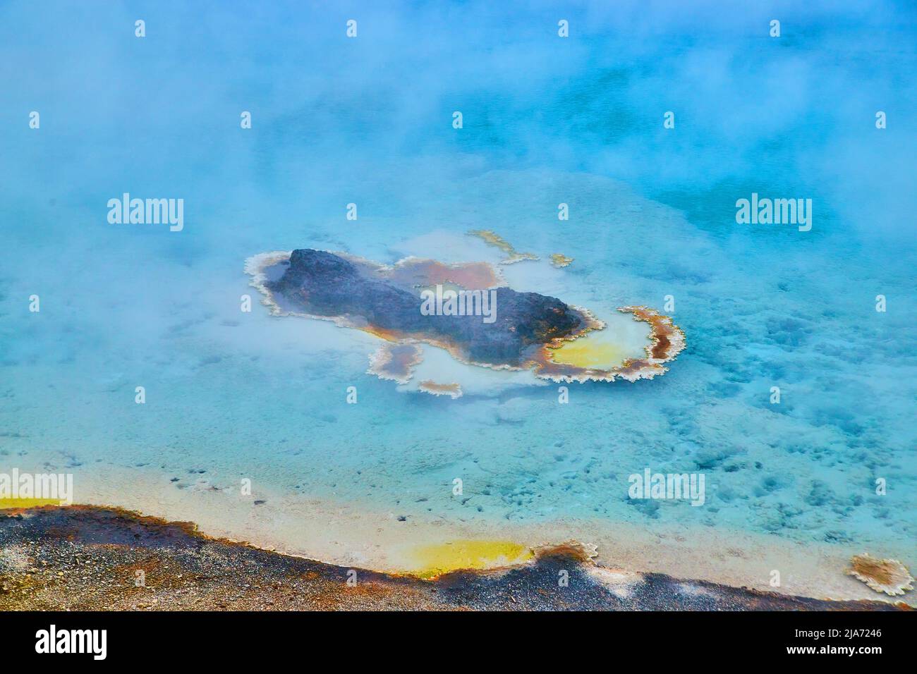 Detail of huge geyser crater spring pools of blue with steam in ...