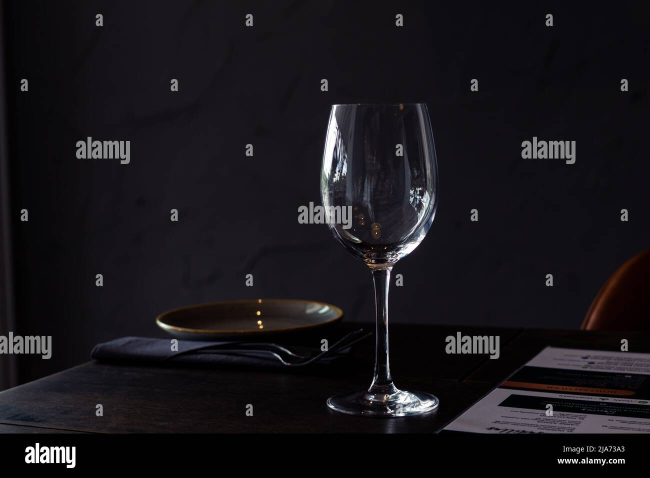 Elegant table setting at restaurant with a plate, glass and menu Stock ...
