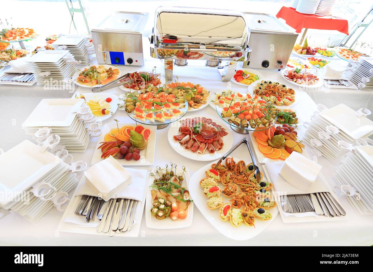 catering table set service with silverware and glass stemware at ...