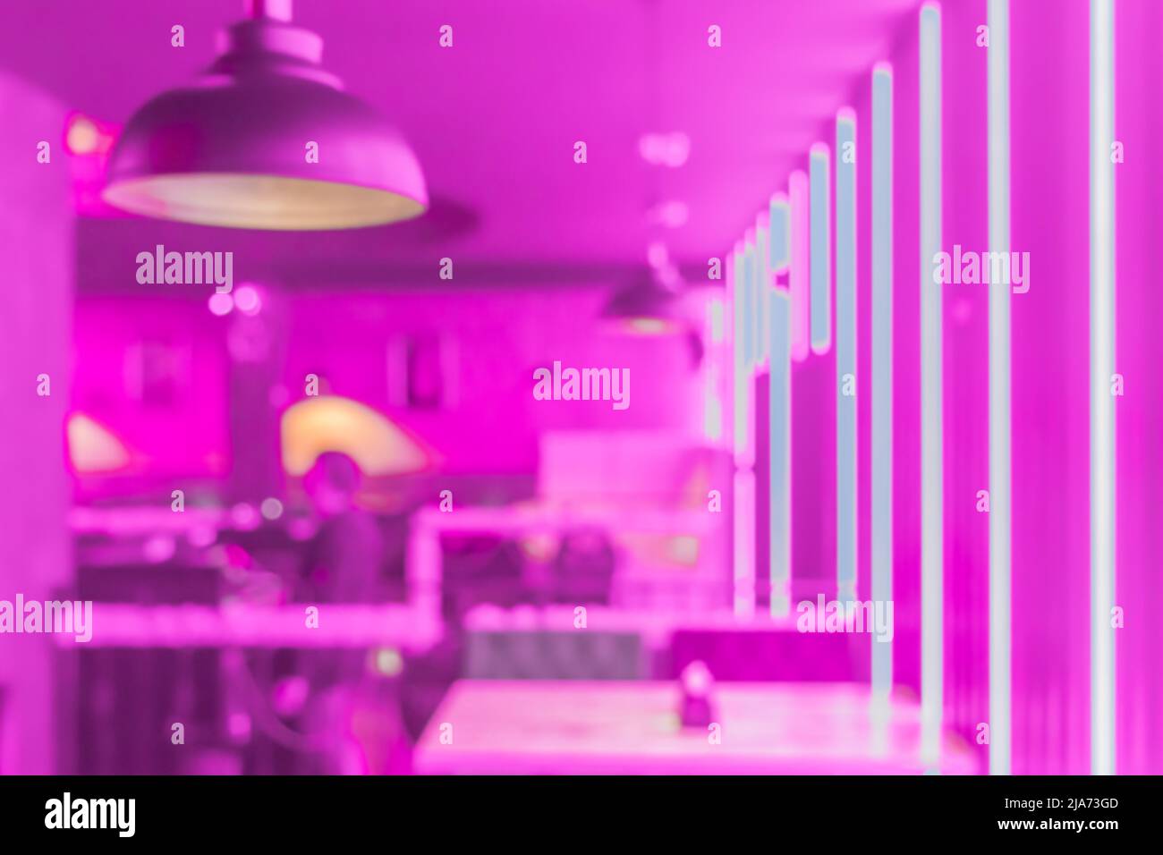 Blurred modern abstract interior of a nightclub with neon purple ...