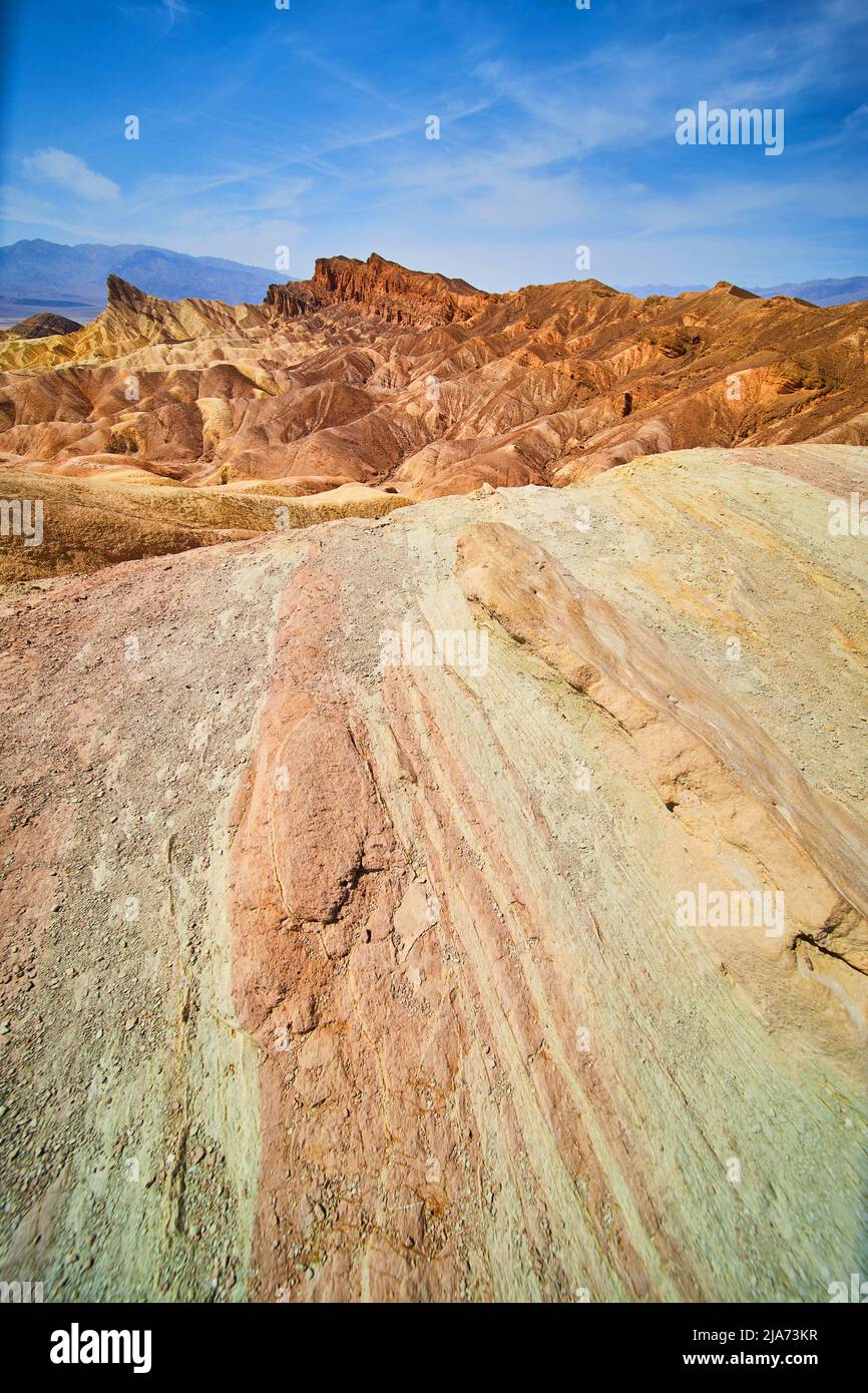 Death Valley rocky sediment formations with colorful mountains in ...