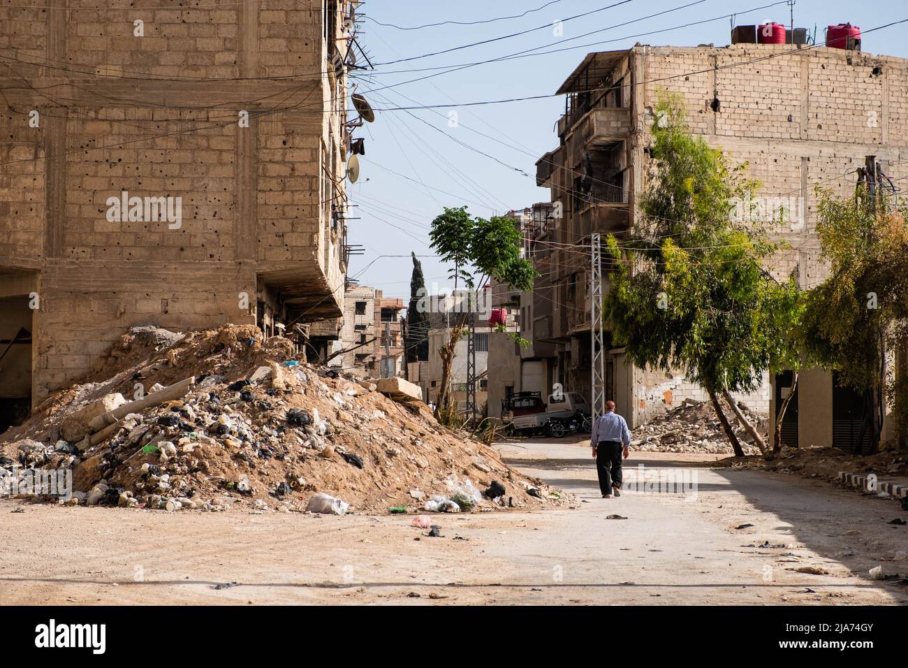 Darayya, Syria - April, 2022: Man walks on street in Darayya after the ...