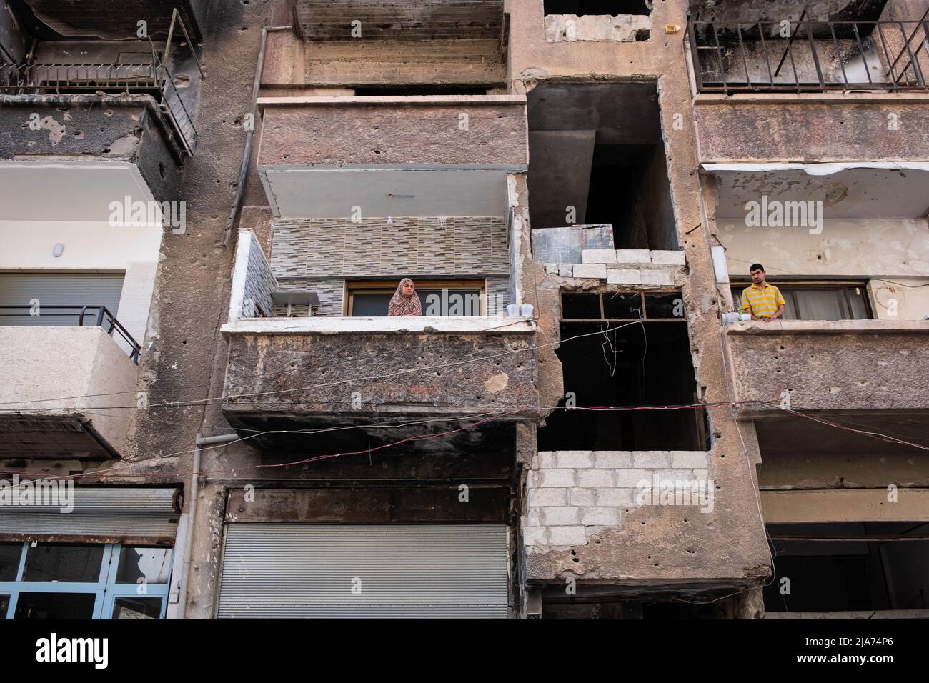 Darayya, Syria - April, 2022:People living in ruins in destroyed city ...