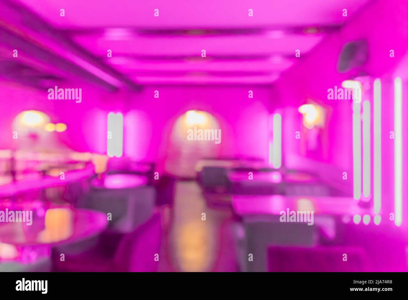 Blurred modern abstract interior of a nightclub with neon purple ...