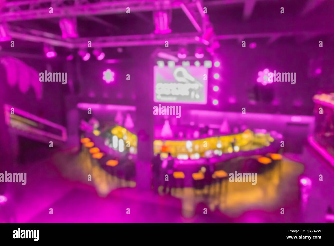 Blurred modern abstract interior of a nightclub with neon purple ...