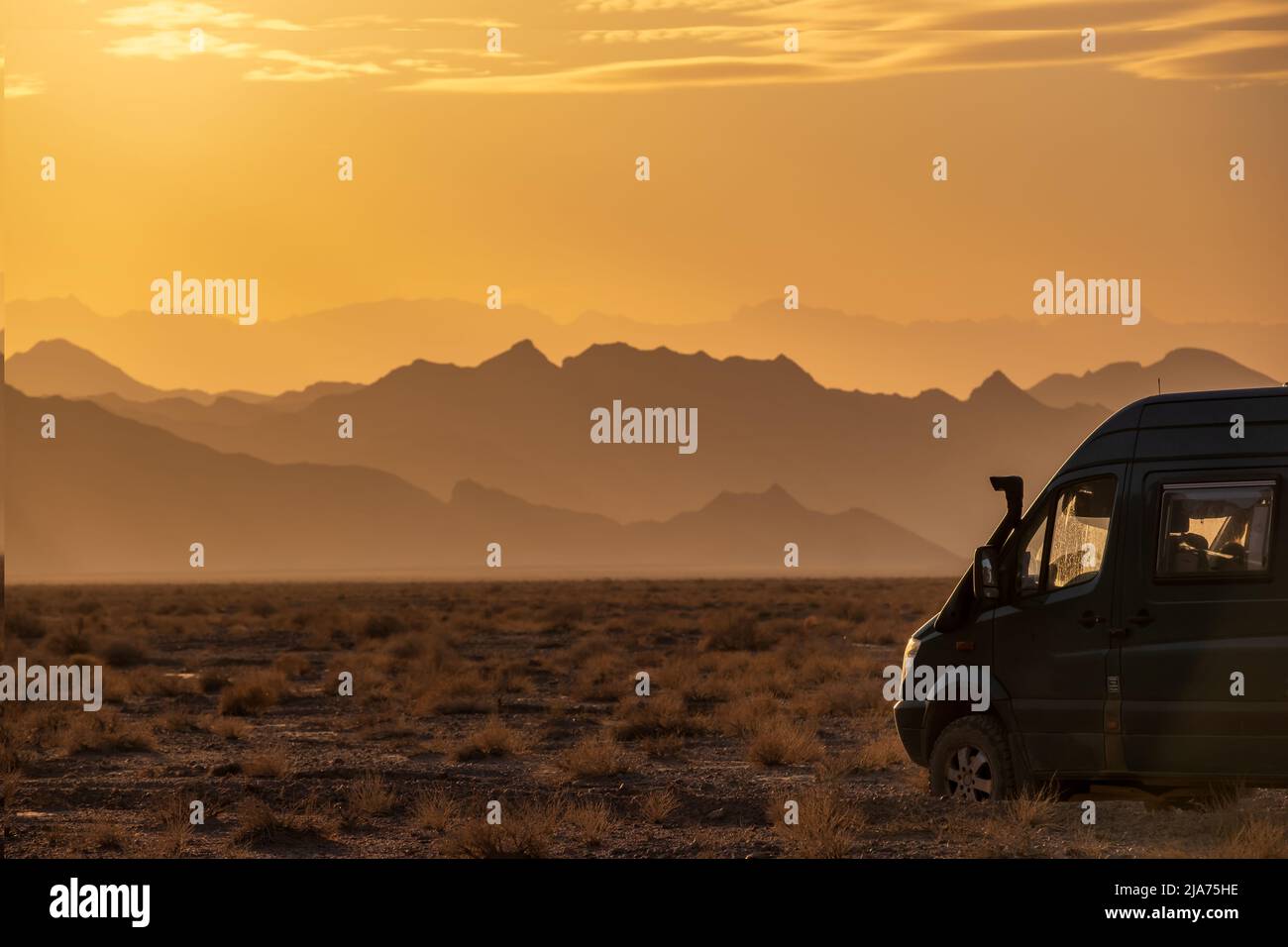 Rugged reliefs of the mountains in the Iranian desert at sunset with a ...