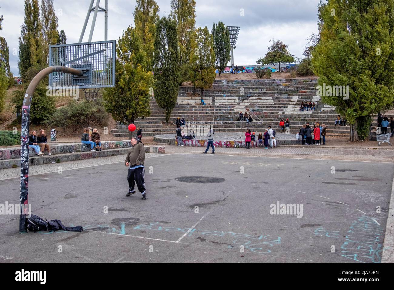Few people sit at the karaoke stage and basketball court in Mauerpark ...