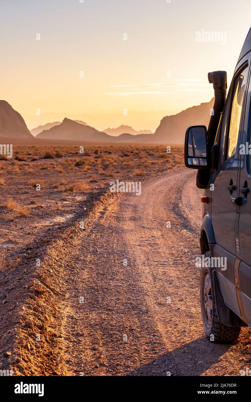 Rugged reliefs of the mountains in the Iranian desert at sunset with a ...