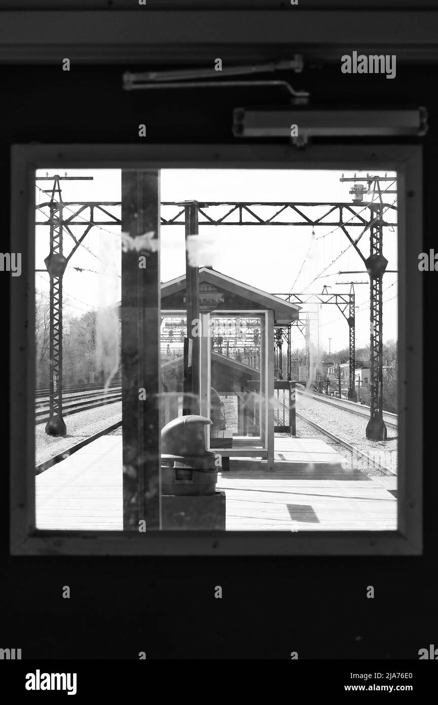 A window on the train station platform with a view of the railroad ...
