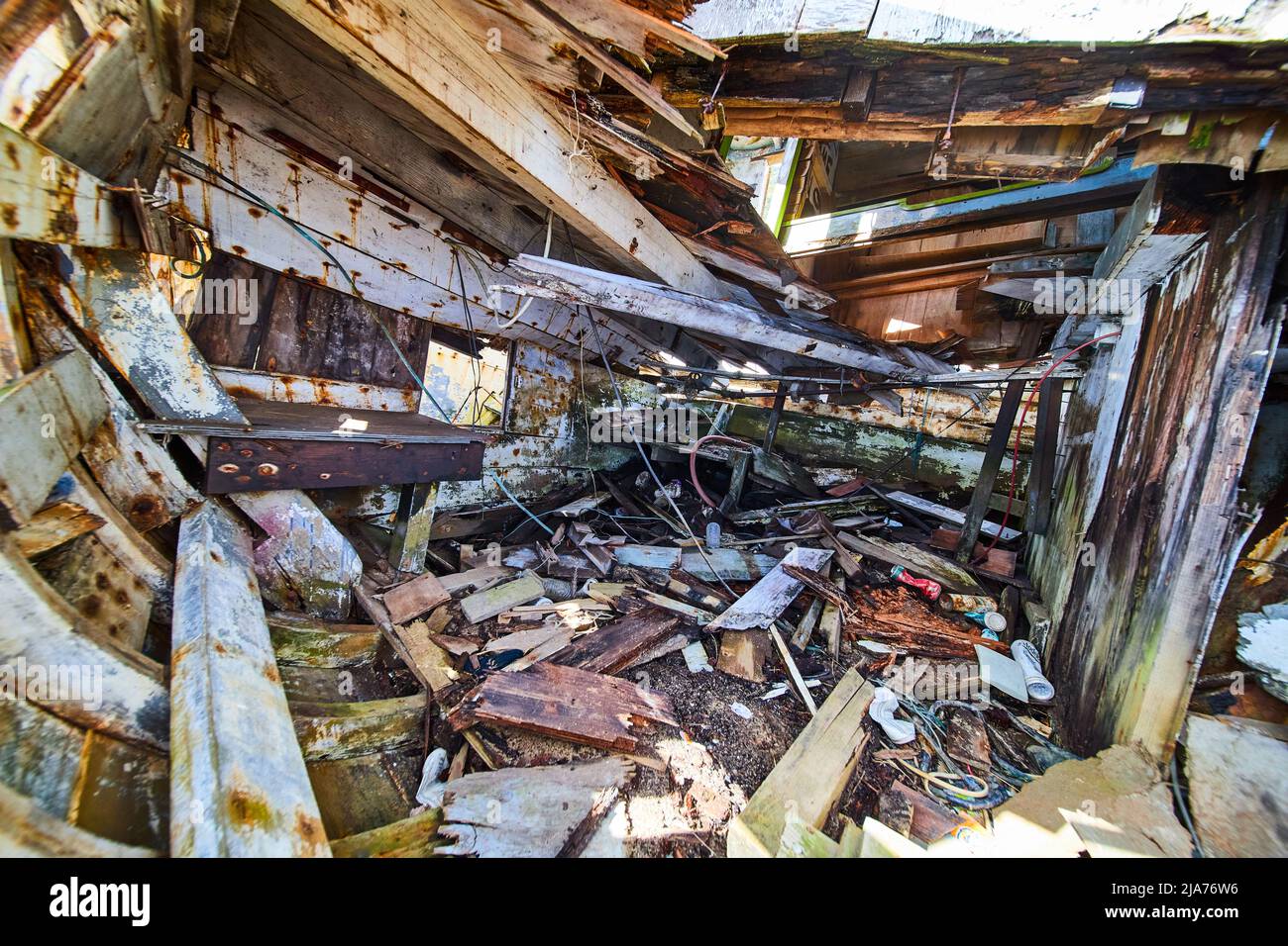 Inside destroyed shipwreck with parts falling on ground Stock Photo - Alamy