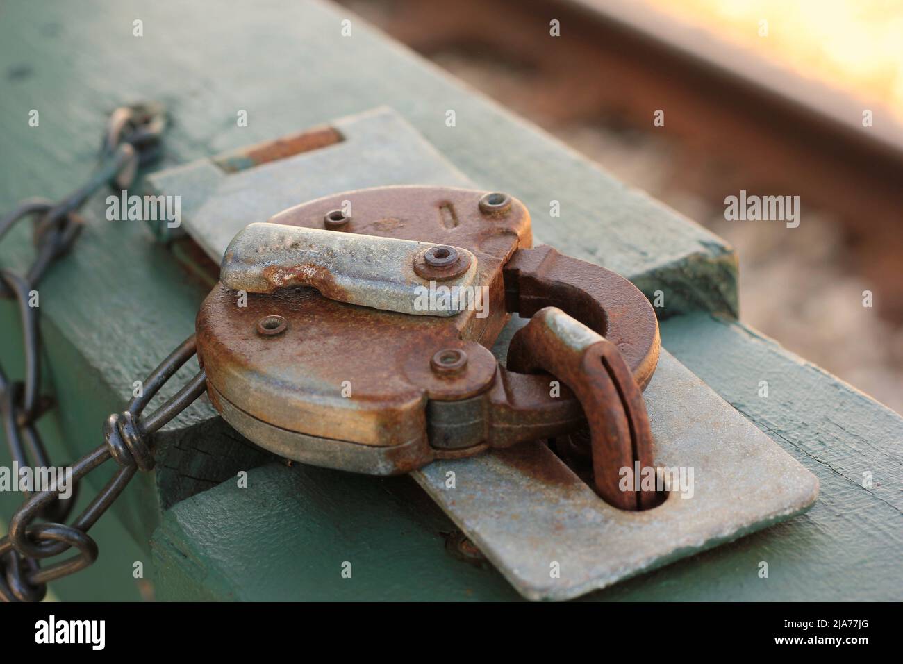 Closeup of a heavy duty lock locking a wooden fence Stock Photo - Alamy