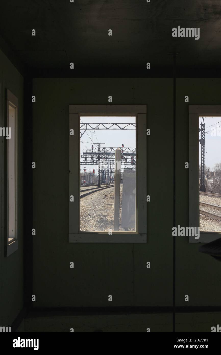 A window on the train station platform with a view of the railroad ...