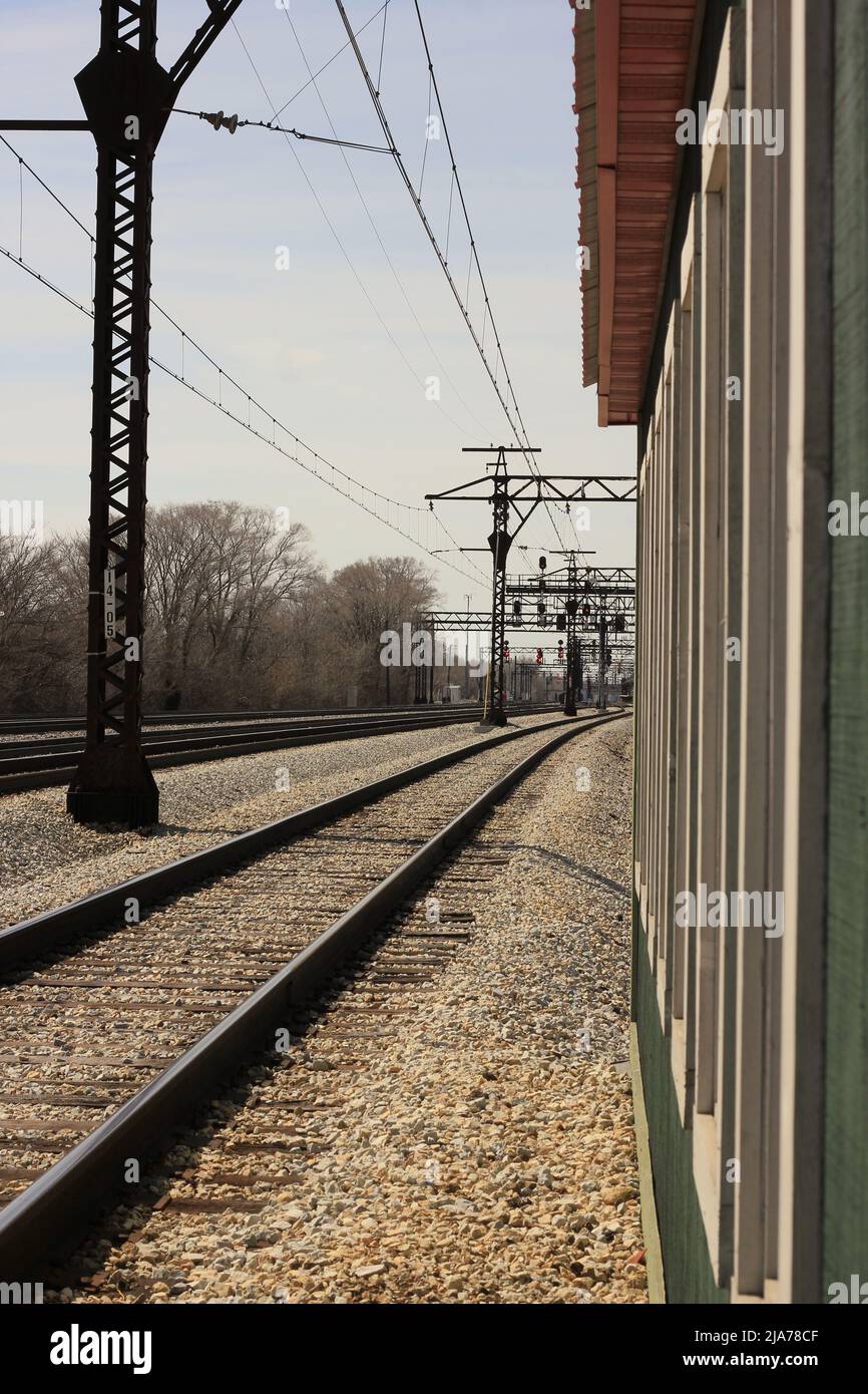 Typical railroad tracks crossing near the public train station platform ...