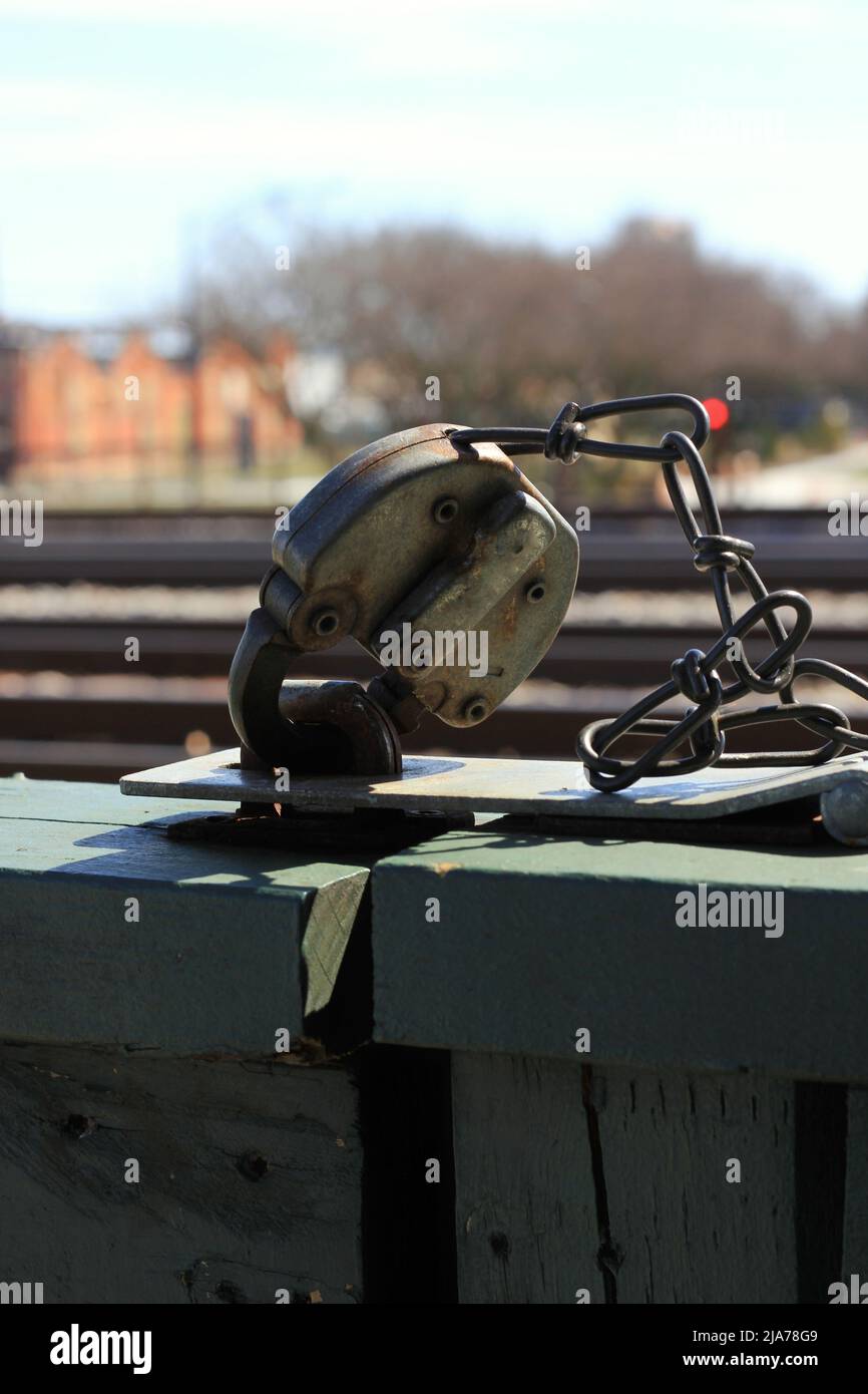 Closeup of a heavy duty lock locking a wooden fence Stock Photo - Alamy