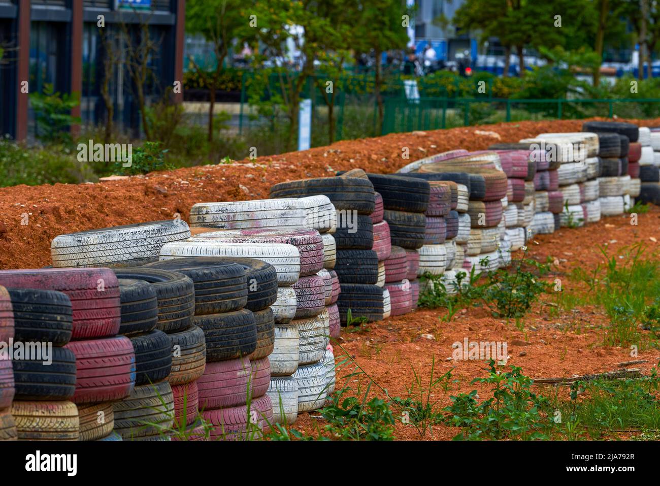 Used tires for fencing on racing track Stock Photo - Alamy