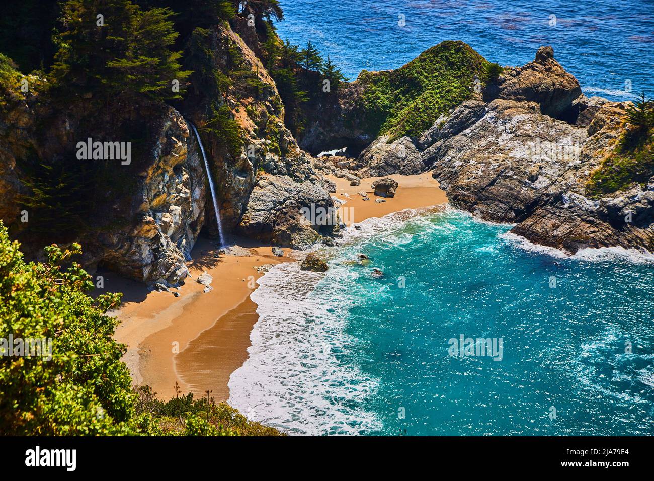 Amazing ocean cove with waterfall, hidden beaches, and coastal rocks ...