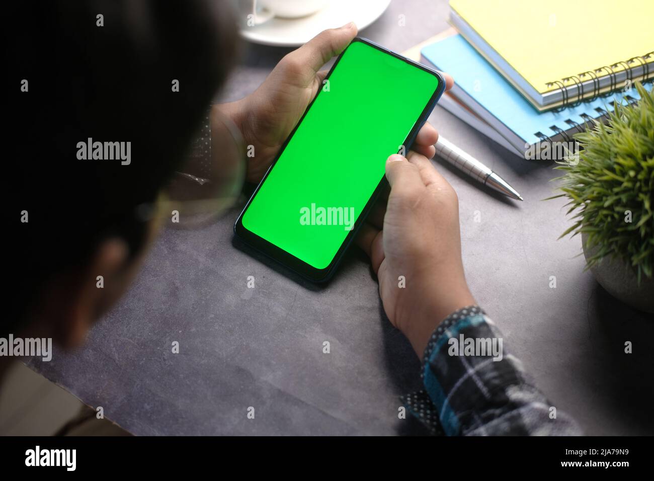 Man scrolling on phone green hi-res stock photography and images - Alamy