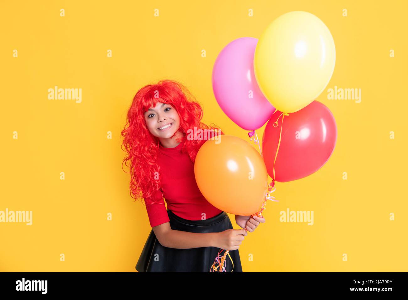 positive kid with party balloon on yellow background Stock Photo - Alamy