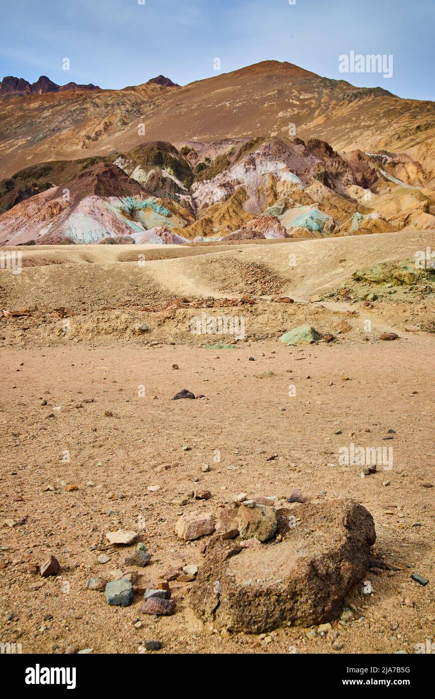 Desert sandy landscape next to colorful mountains Stock Photo - Alamy