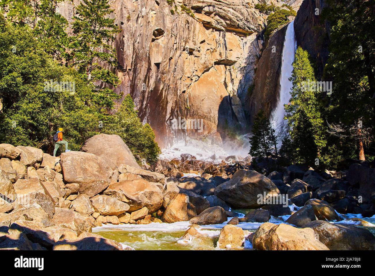 Figure enjoying view at Yosemite of Lower Valls on boulders Stock Photo ...