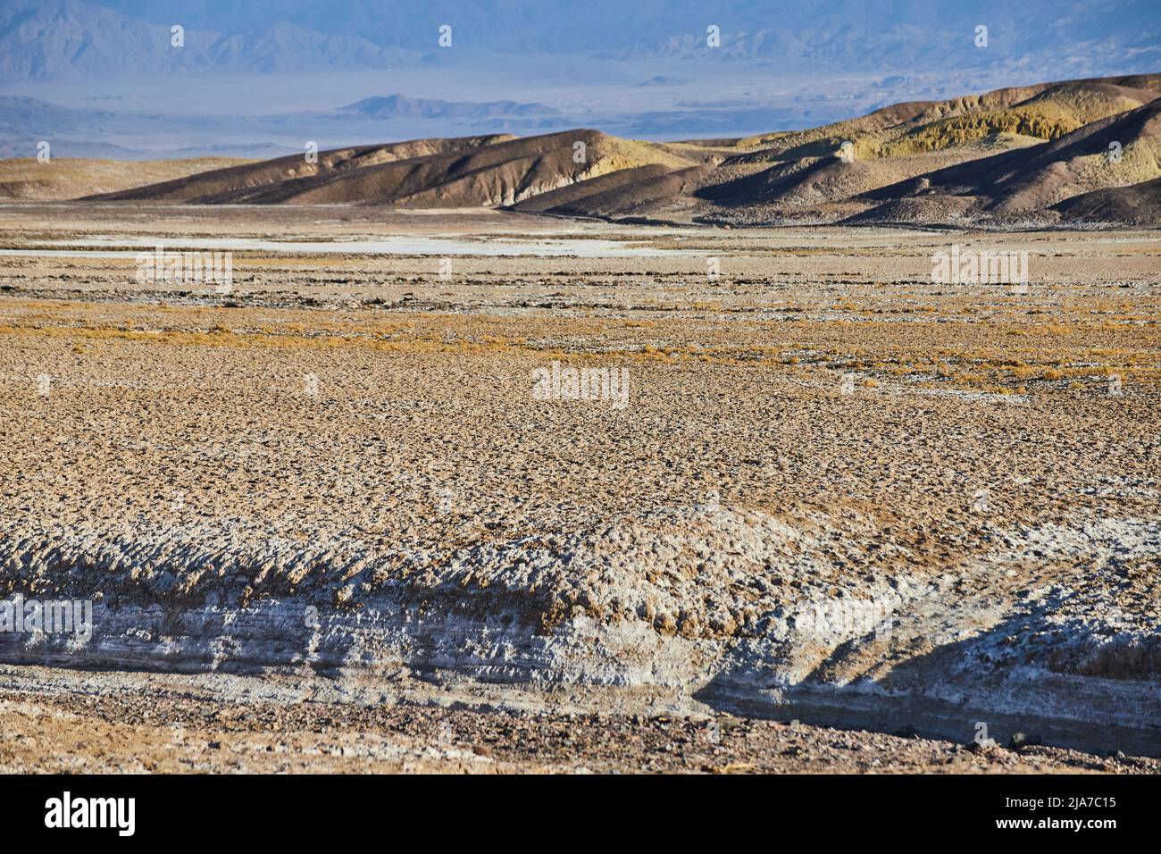 Landscape of desert field with mountains in background Stock Photo - Alamy